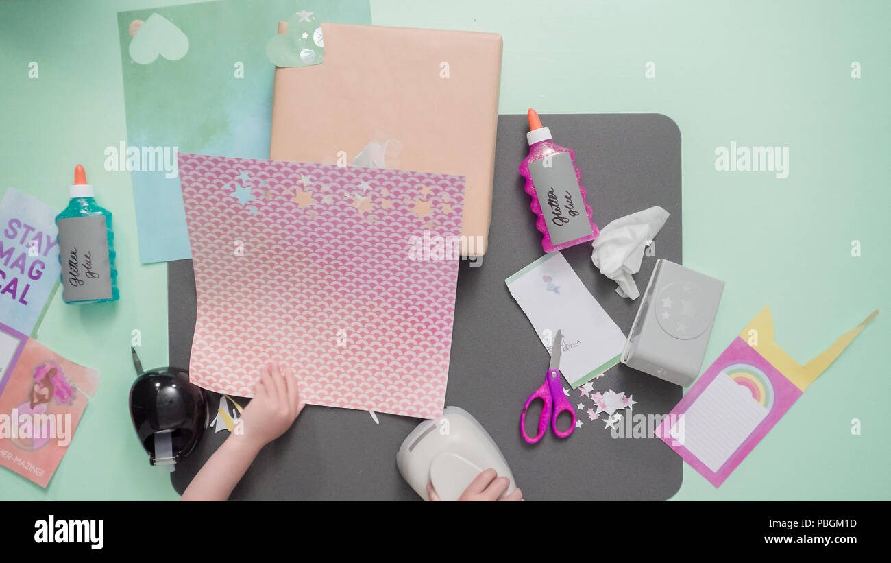 Decorating present for kids birthday with craft paper Stock Photo - Alamy