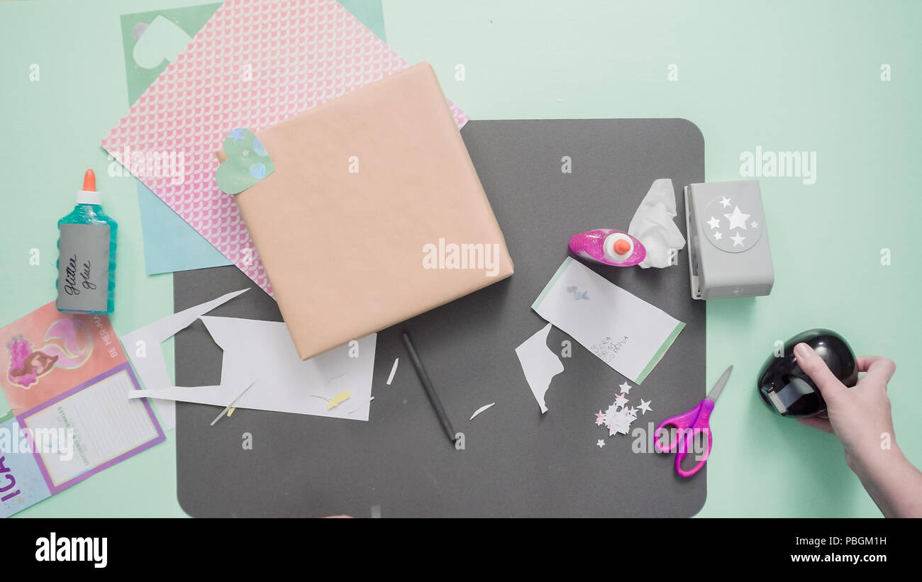 Decorating present for kids birthday with craft paper Stock Photo - Alamy