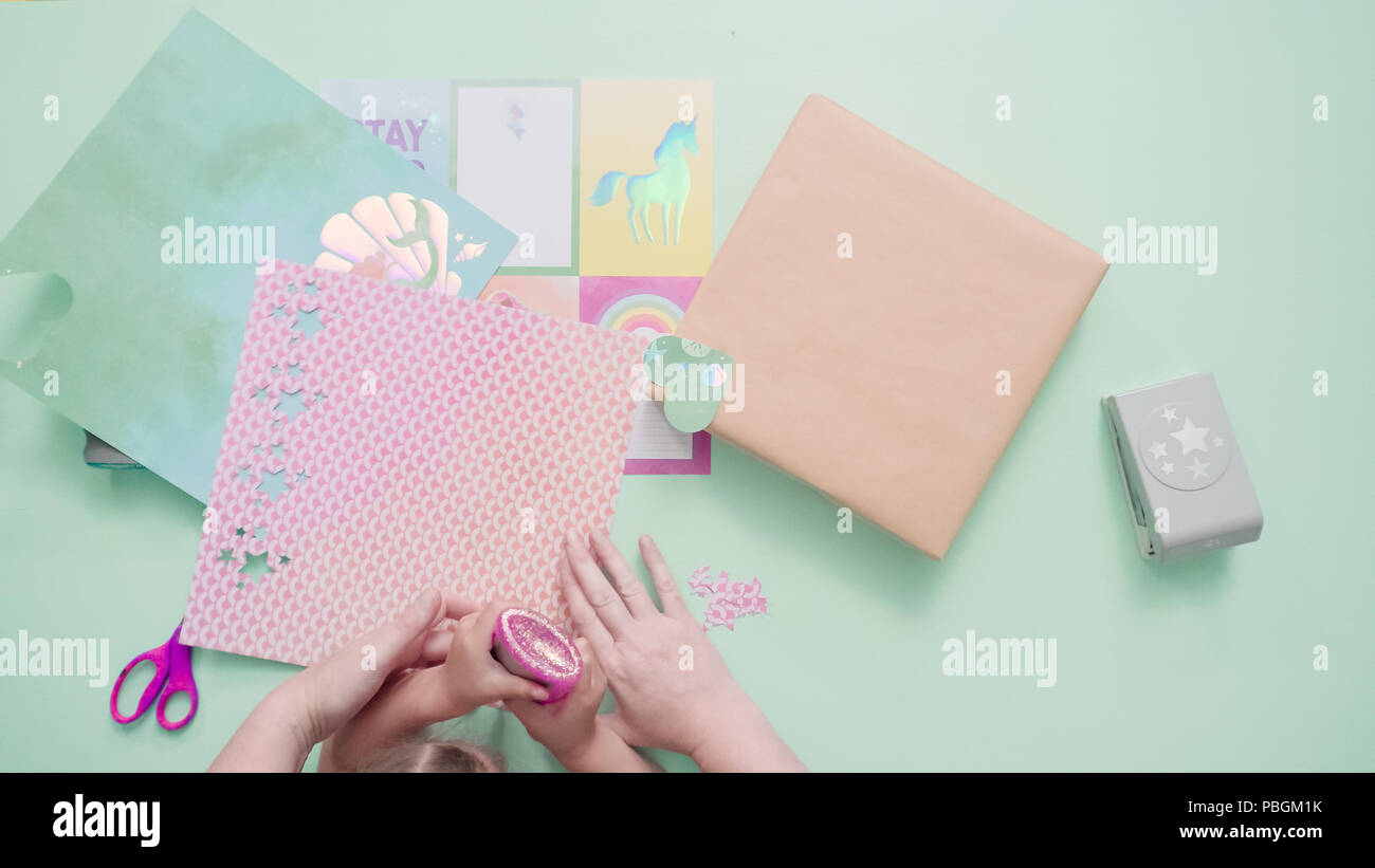 Decorating present for kids birthday with craft paper Stock Photo - Alamy