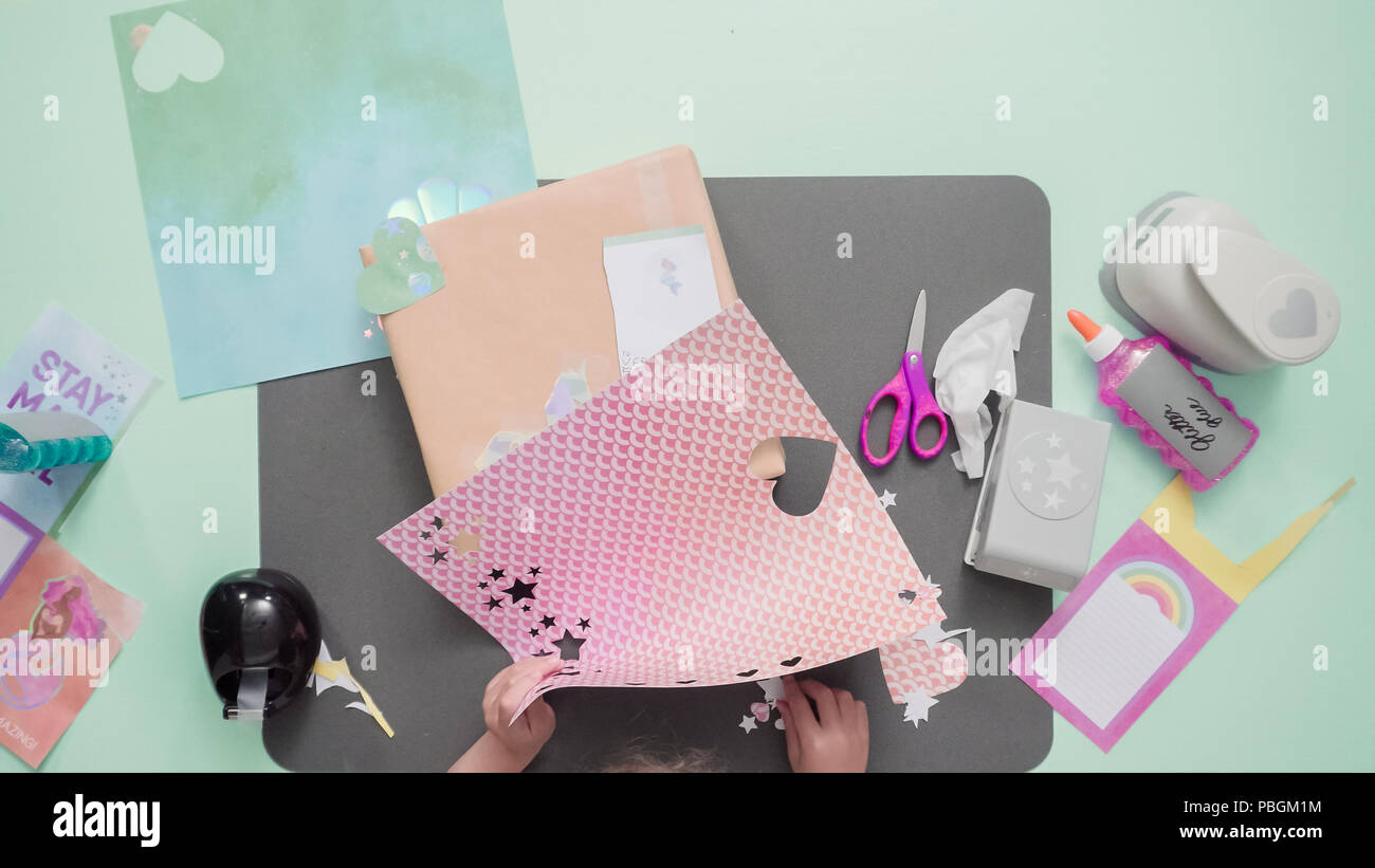 Decorating present for kids birthday with craft paper Stock Photo - Alamy