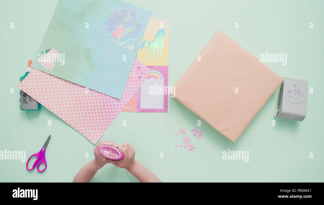 Decorating present for kids birthday with craft paper Stock Photo - Alamy