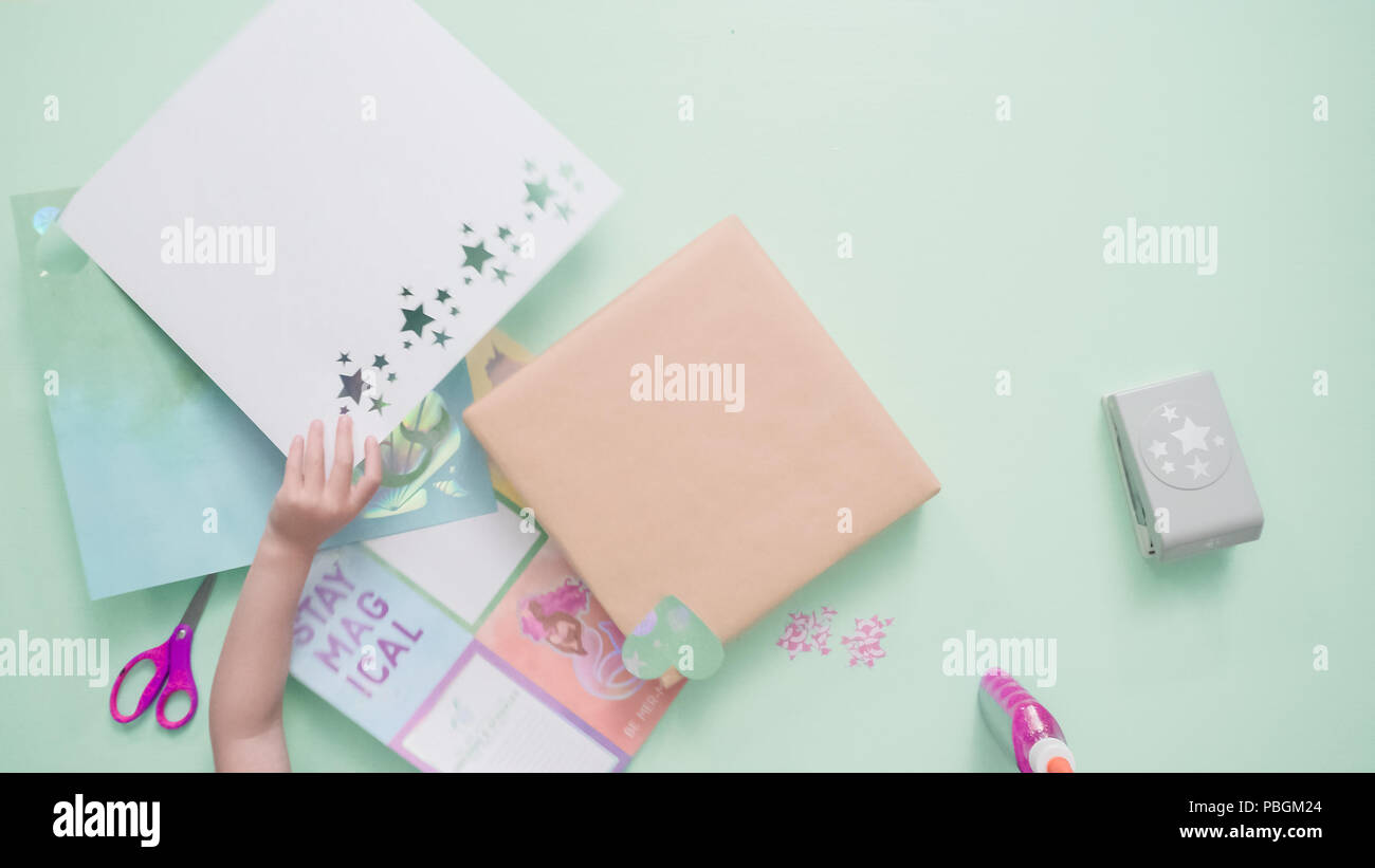 Decorating present for kids birthday with craft paper Stock Photo - Alamy