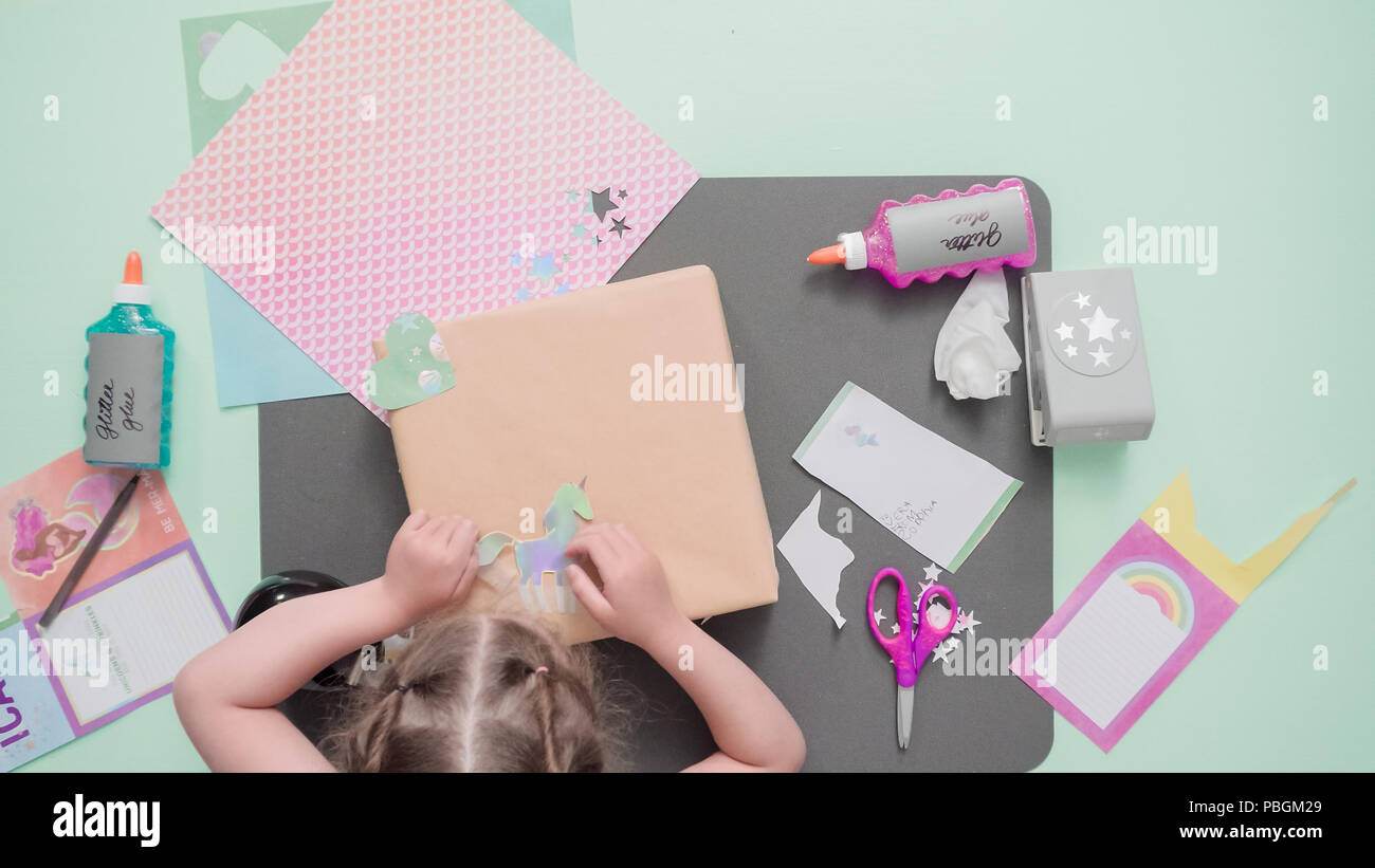 Decorating present for kids birthday with craft paper Stock Photo - Alamy