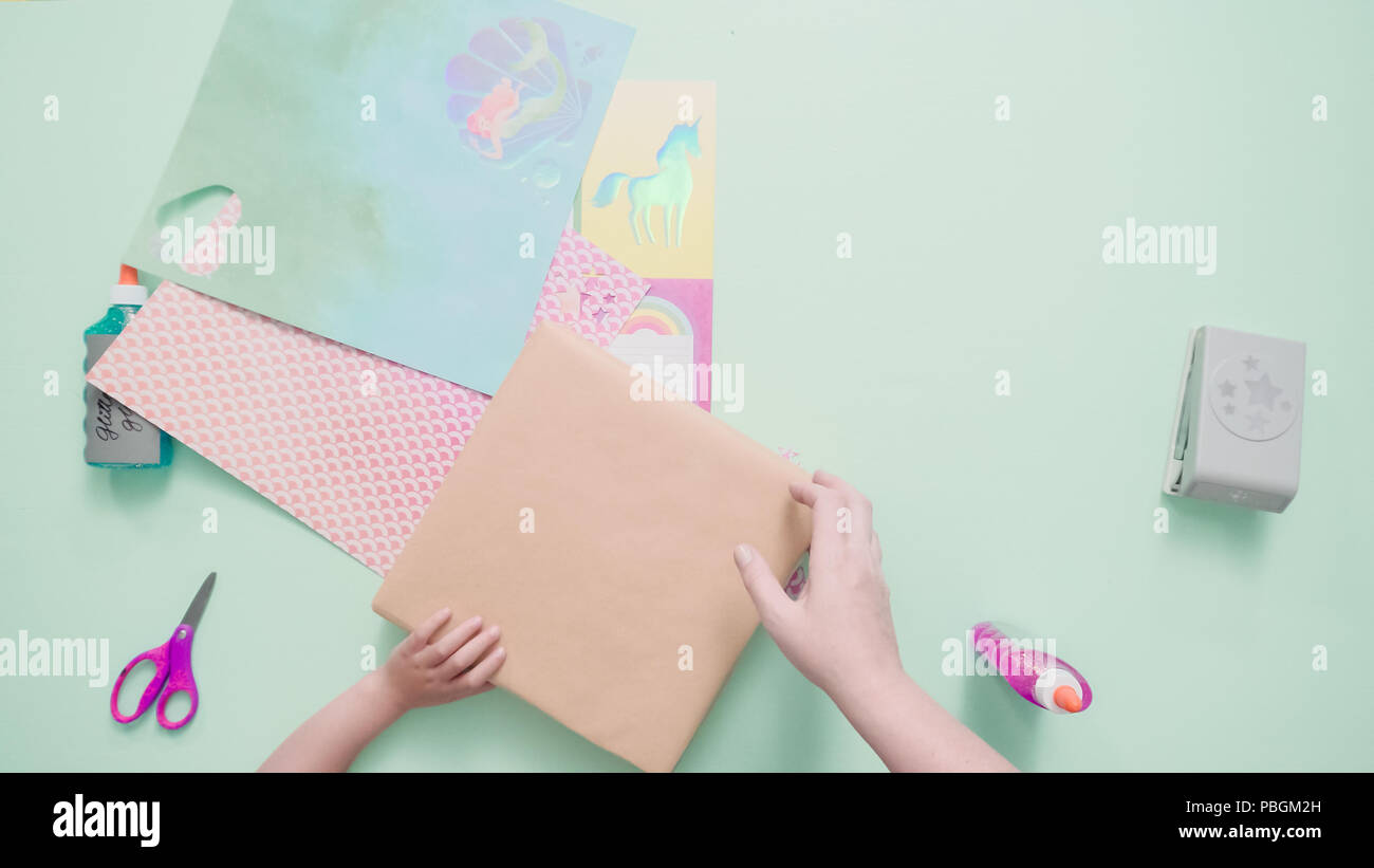 Decorating present for kids birthday with craft paper Stock Photo - Alamy