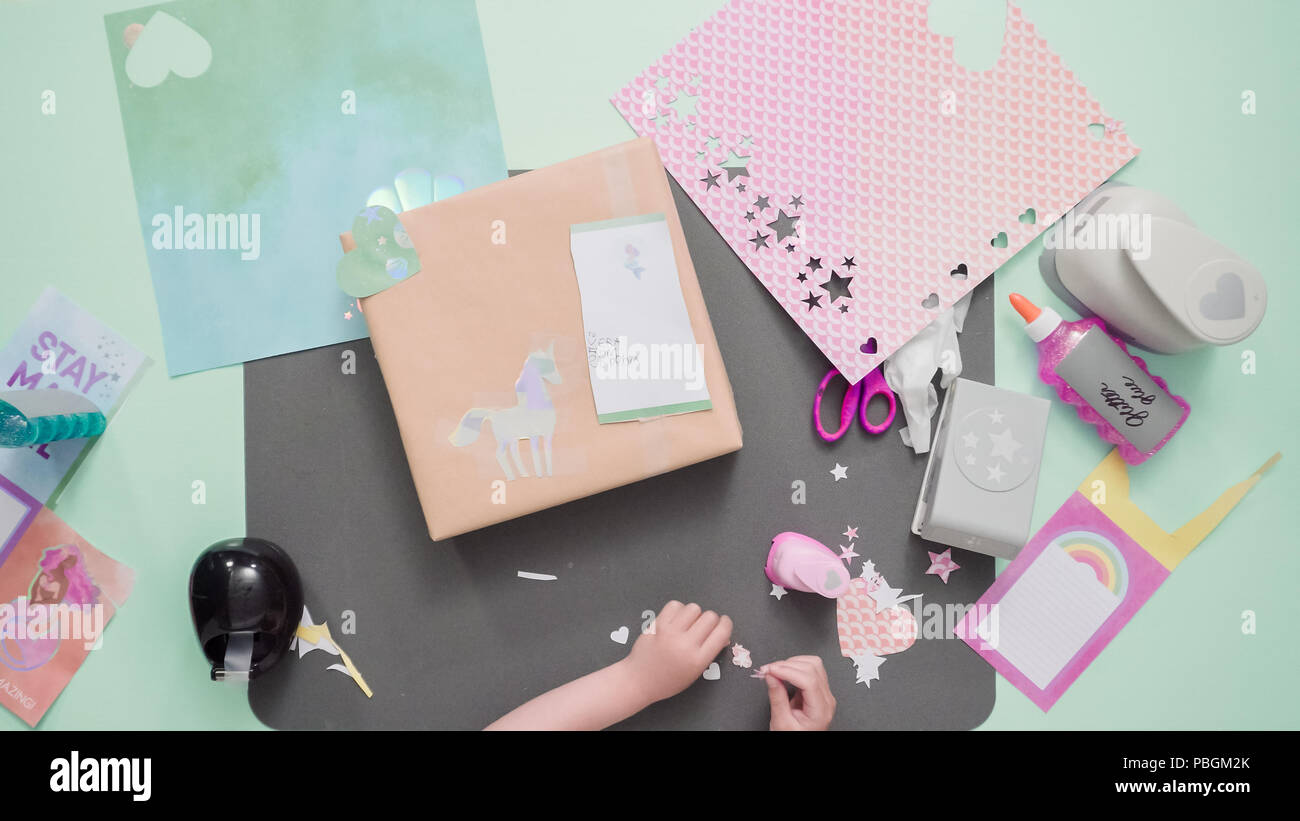 Decorating present for kids birthday with craft paper Stock Photo - Alamy