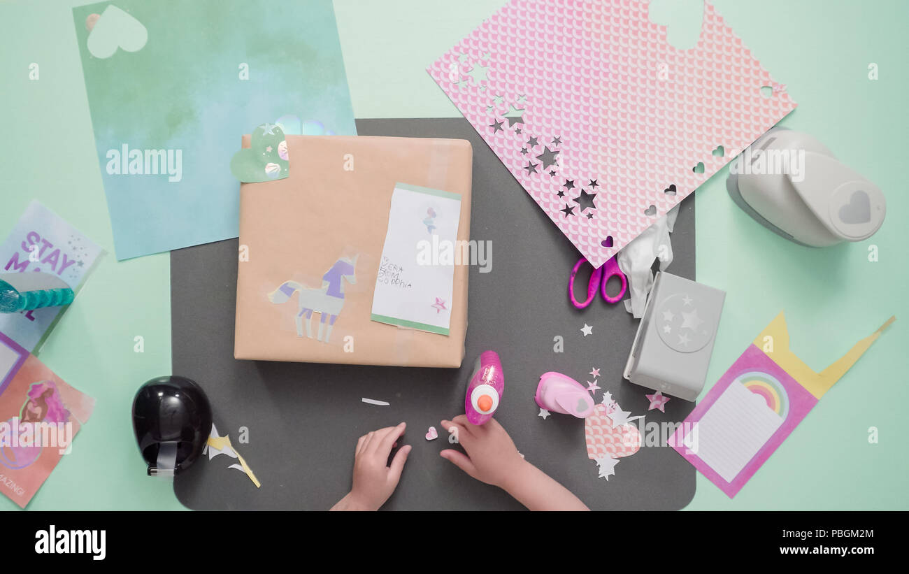 Decorating present for kids birthday with craft paper Stock Photo - Alamy