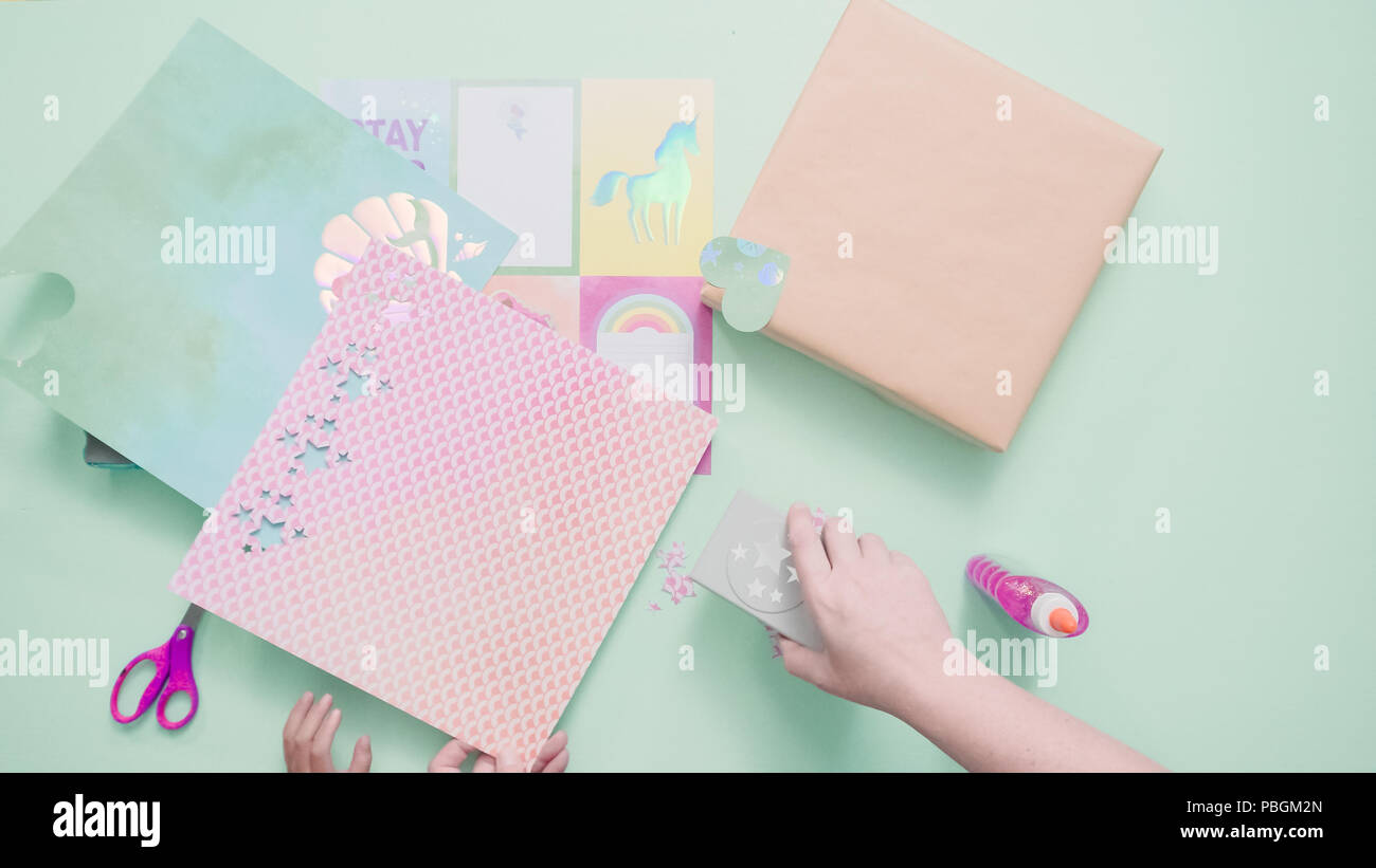 Decorating present for kids birthday with craft paper Stock Photo - Alamy