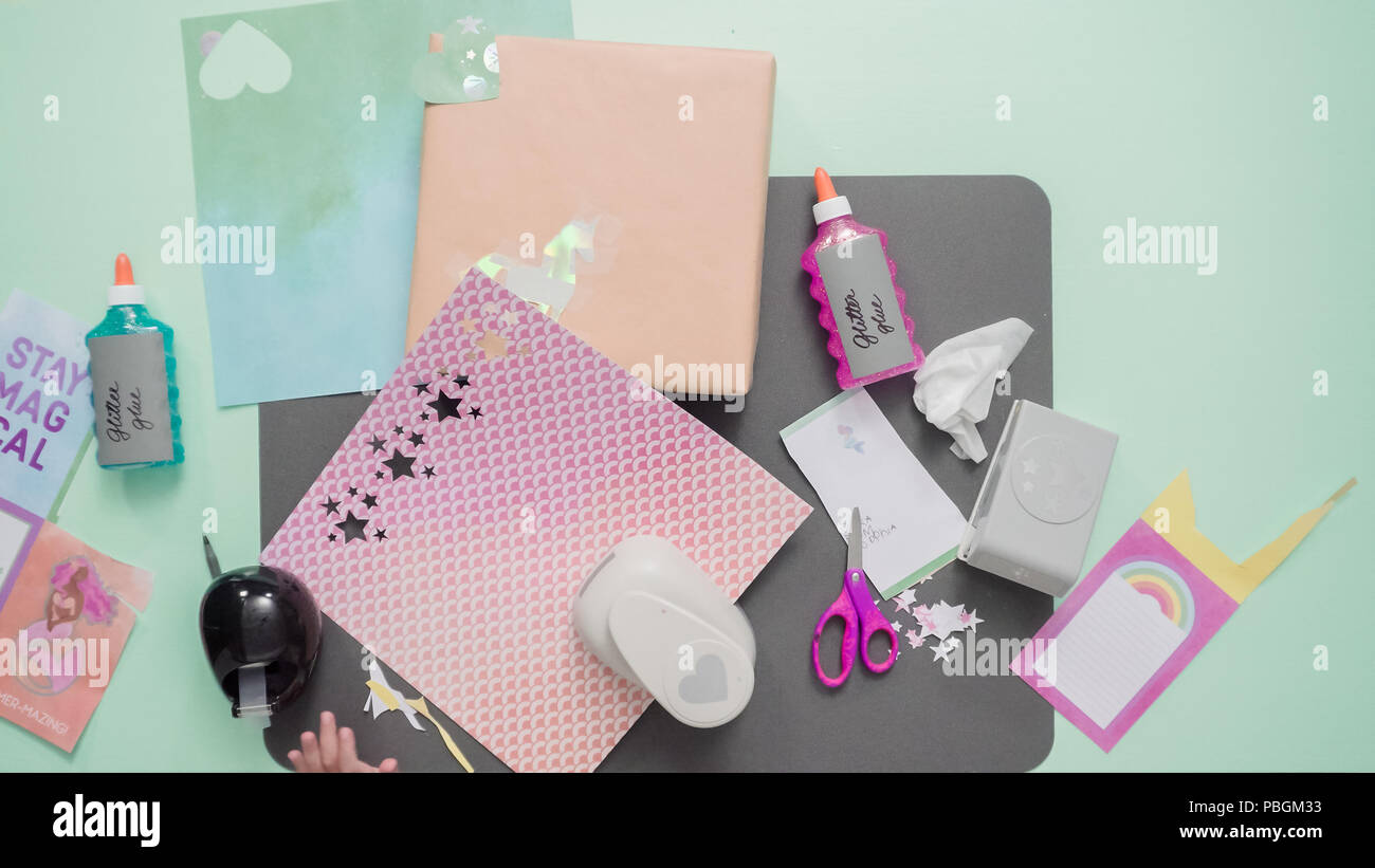 Decorating present for kids birthday with craft paper Stock Photo - Alamy