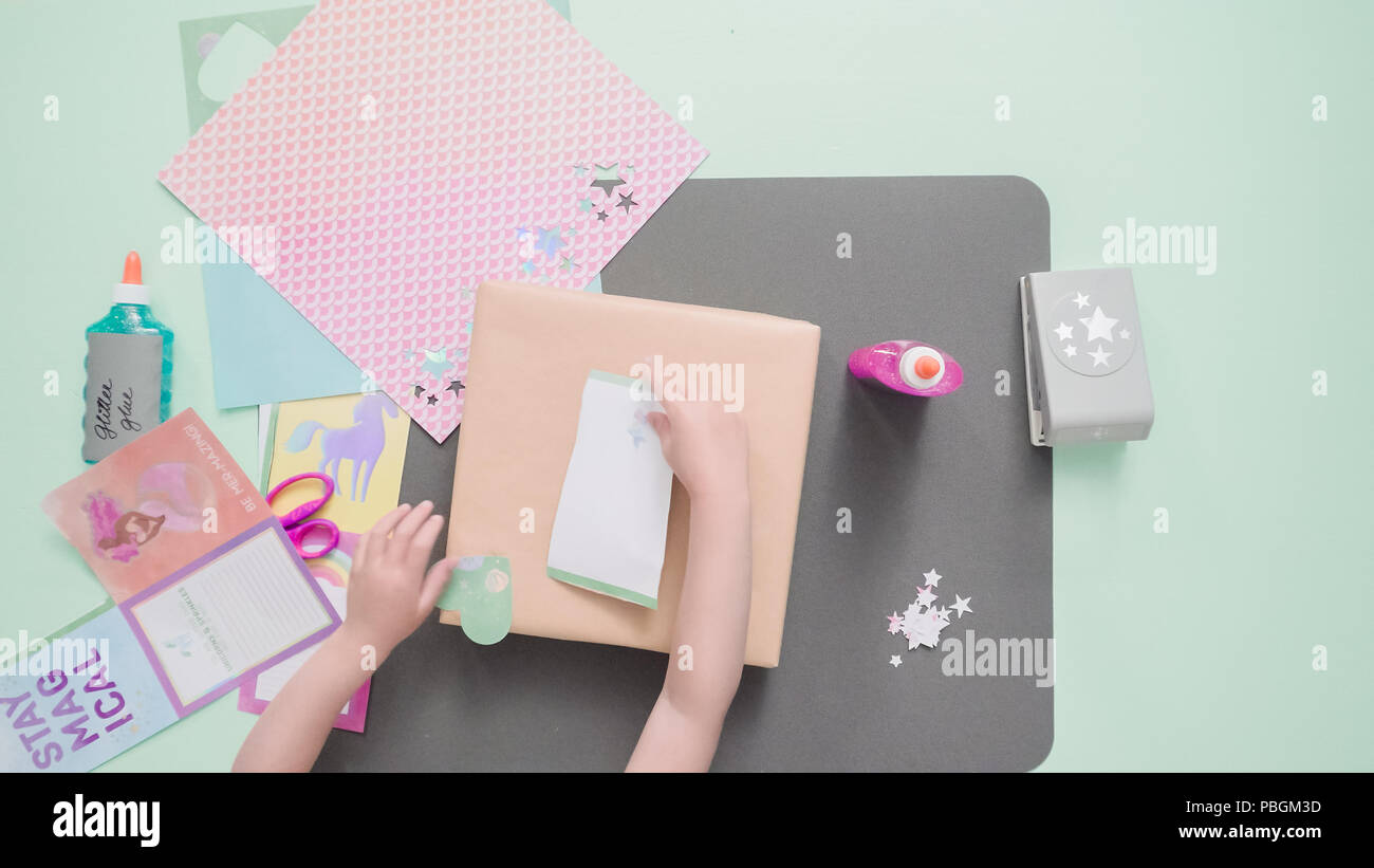 Decorating present for kids birthday with craft paper Stock Photo - Alamy