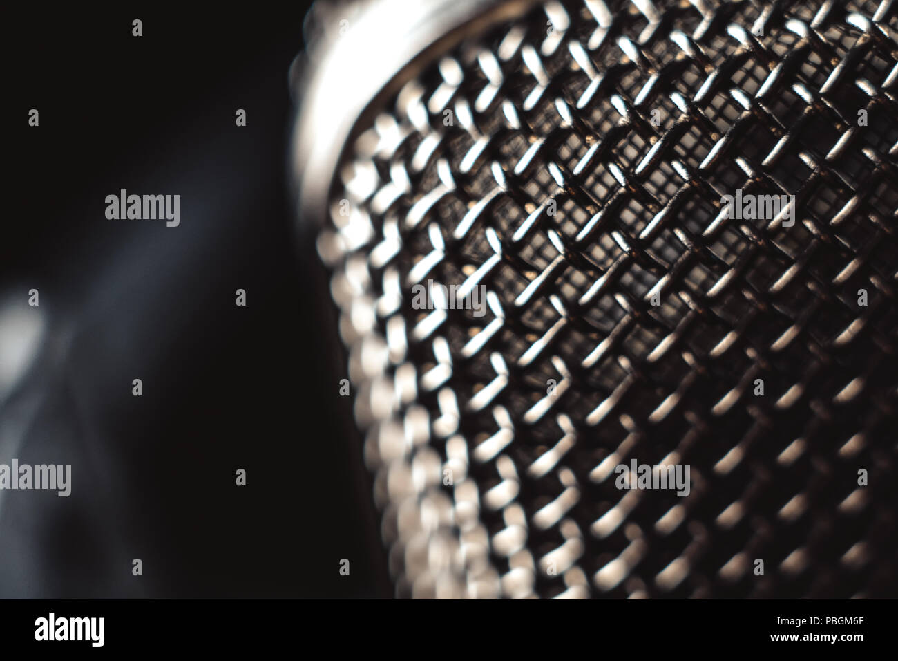 metal microphone Grille, black background macro photography Stock Photo ...