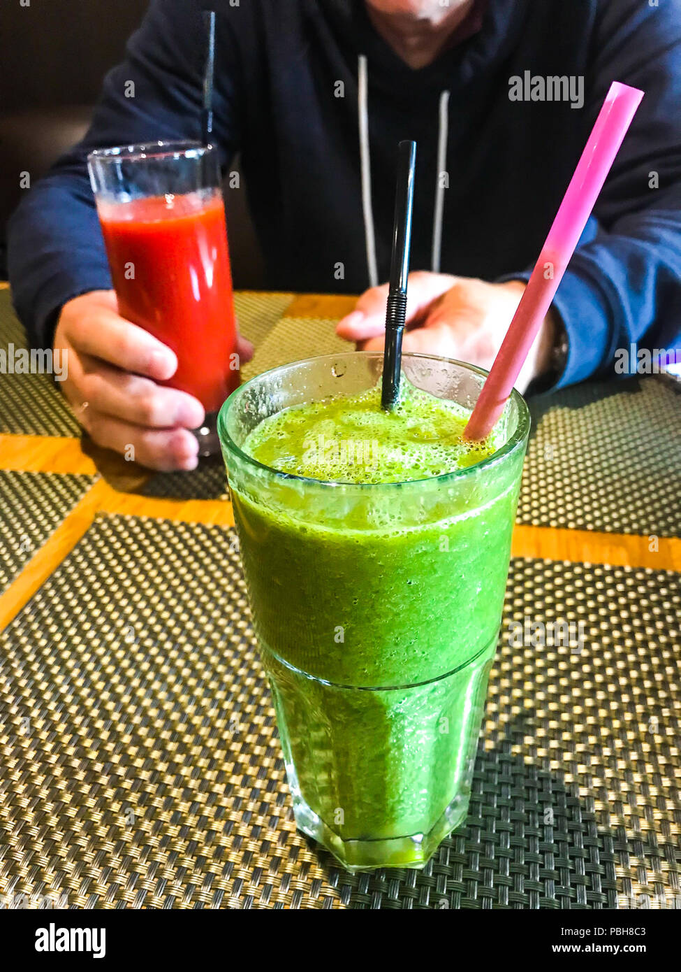 Green vegetable smoothie in glass on table in cafe. Studio Photo Stock ...
