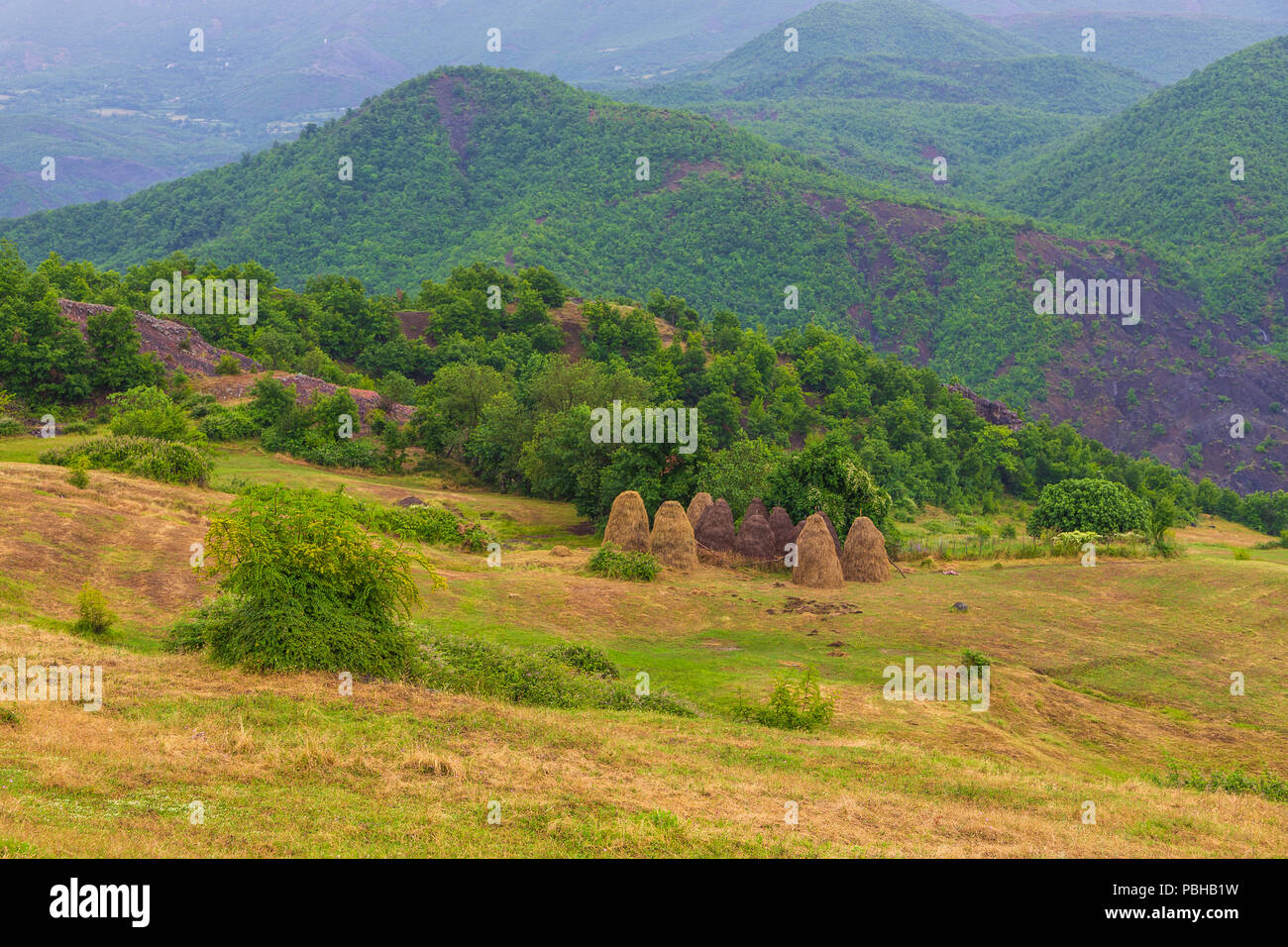Scenic landscape view in Albanian mountain with hay shocks Stock Photo ...