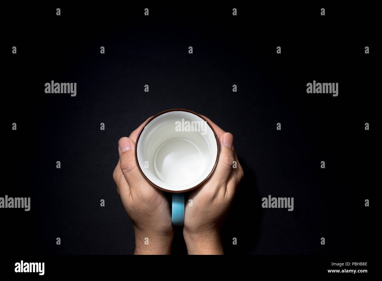 cup in palm on the black background Stock Photo - Alamy