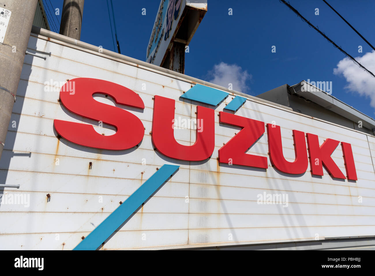 Suzuki sign on a wall; Japan Stock Photo - Alamy