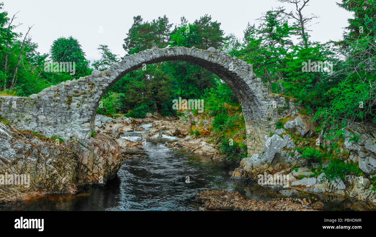Famous stone bridge over a creek in the village of Carrbridge Scotland ...