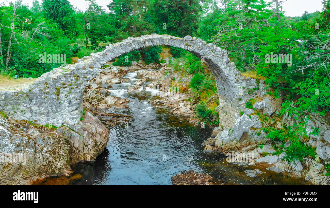 Famous stone bridge over a creek in the village of Carrbridge Scotland ...