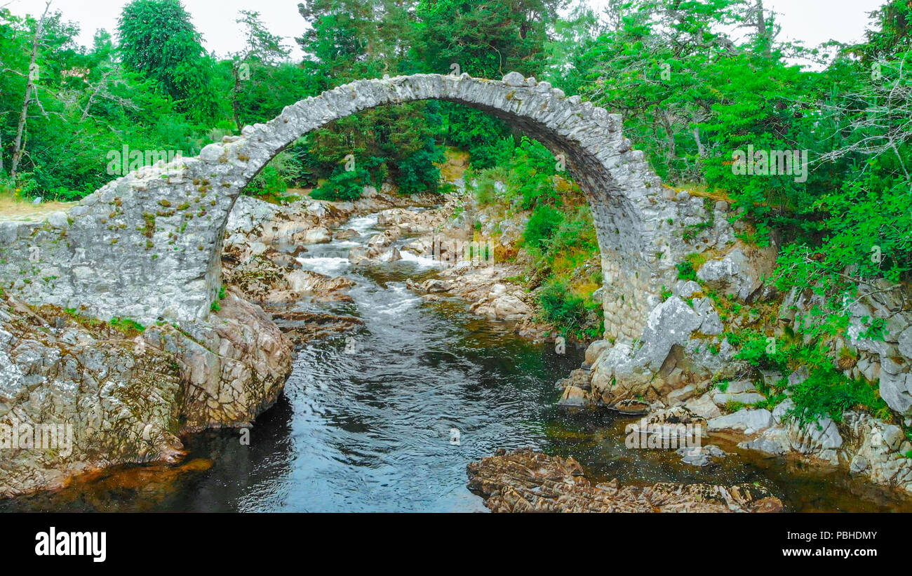 Famous stone bridge over a creek in the village of Carrbridge Scotland ...