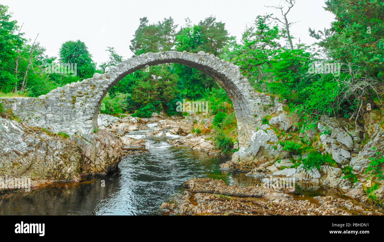 Famous stone bridge over a creek in the village of Carrbridge Scotland ...