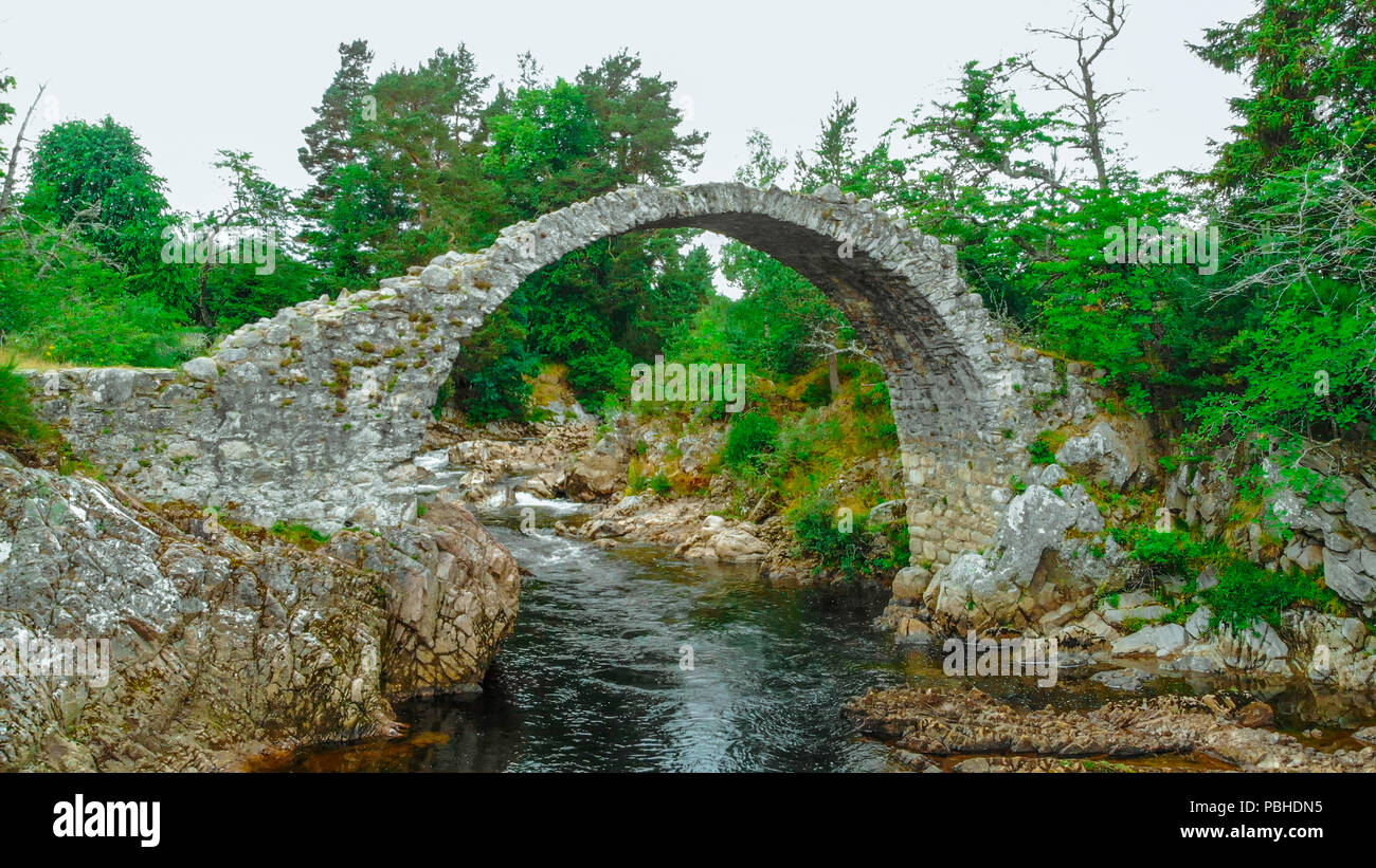 Famous stone bridge over a creek in the village of Carrbridge Scotland ...
