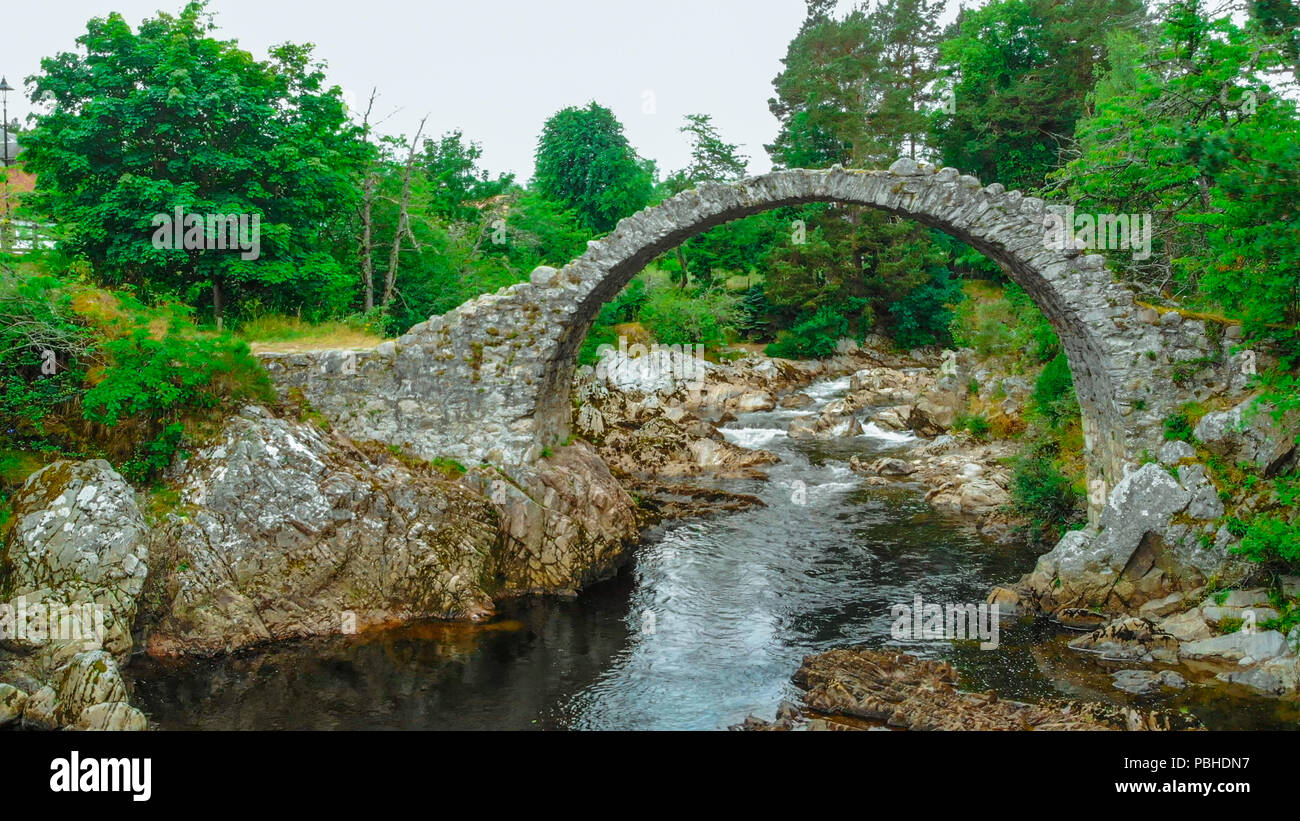 Famous stone bridge over a creek in the village of Carrbridge Scotland ...