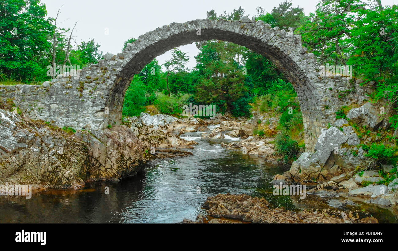 Famous stone bridge over a creek in the village of Carrbridge Scotland ...