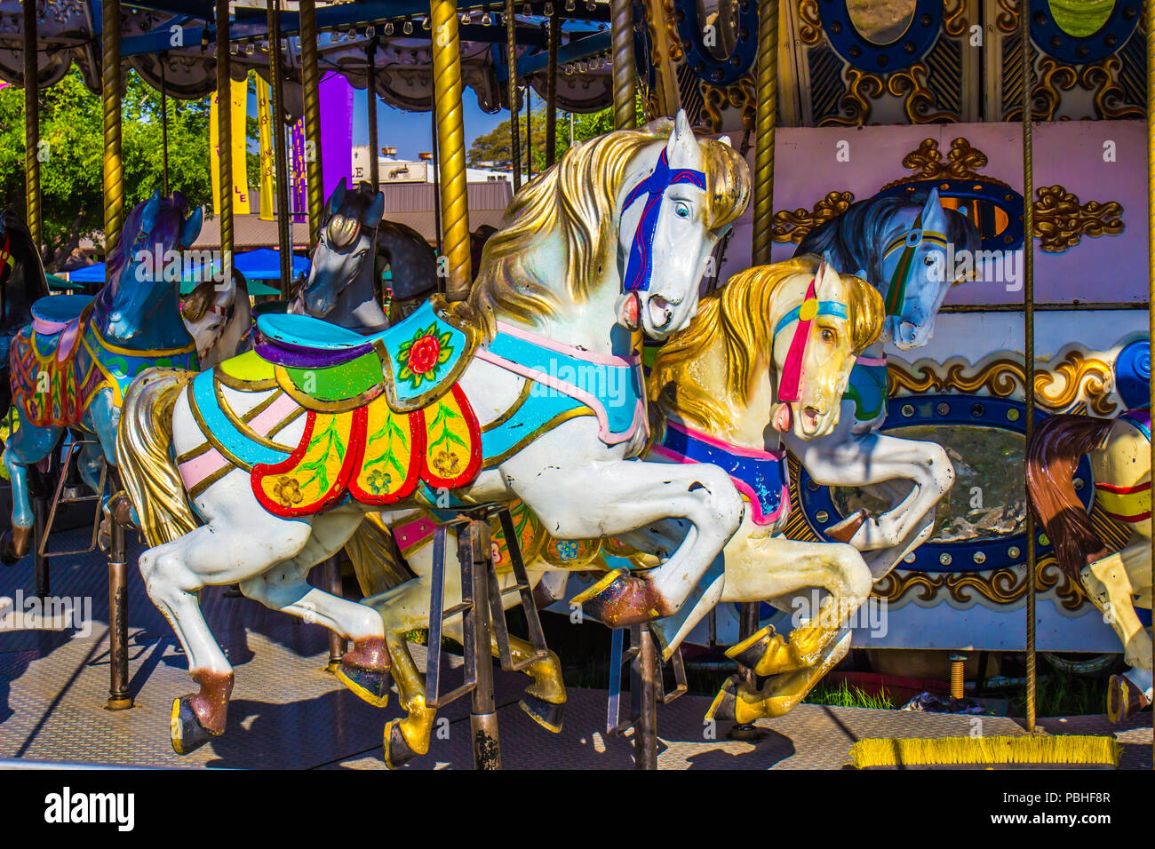 Row Of Wooden Horses On Merry Go Round Stock Photo - Alamy