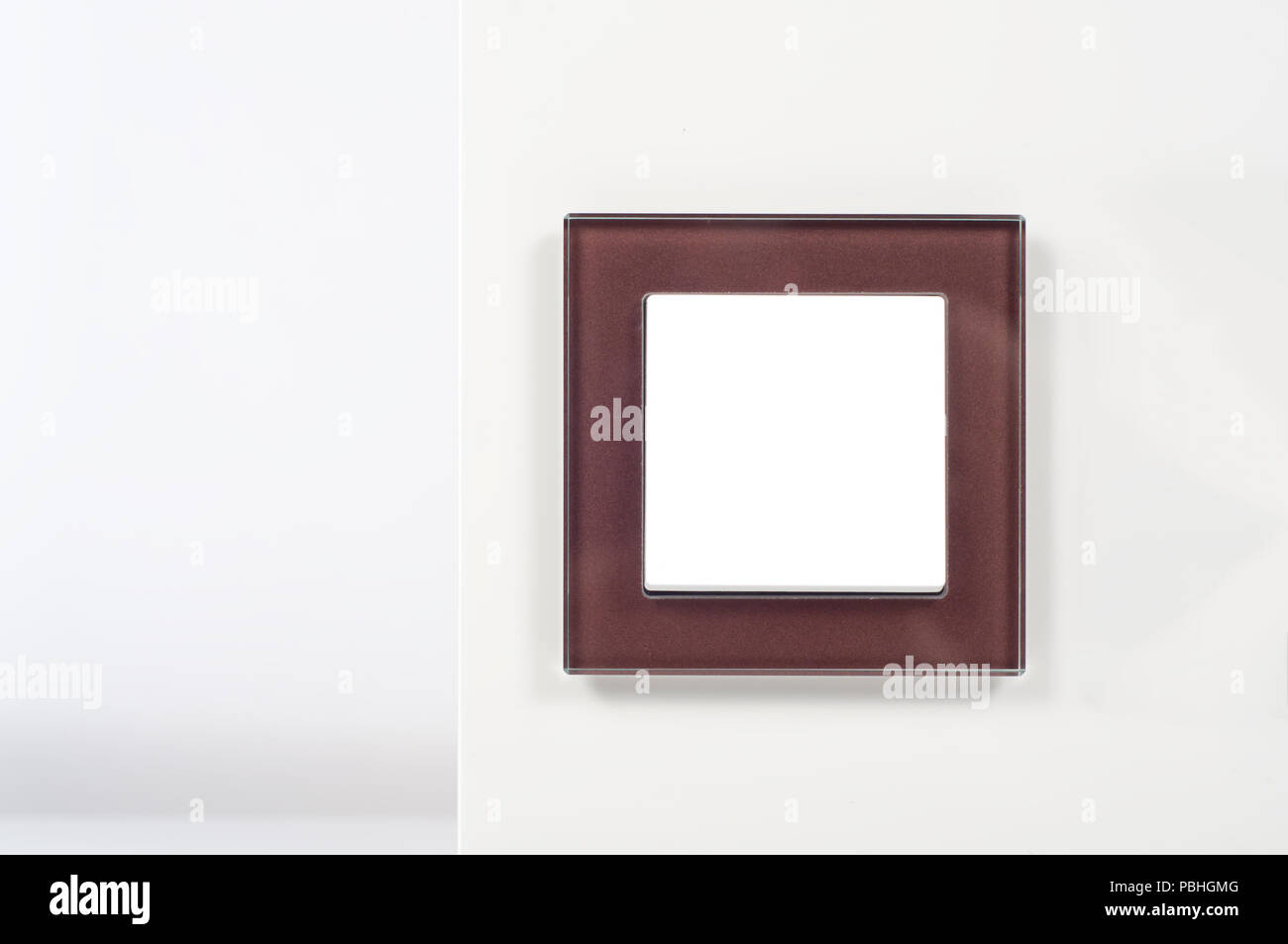 light switch with glass frame on the wall Stock Photo - Alamy