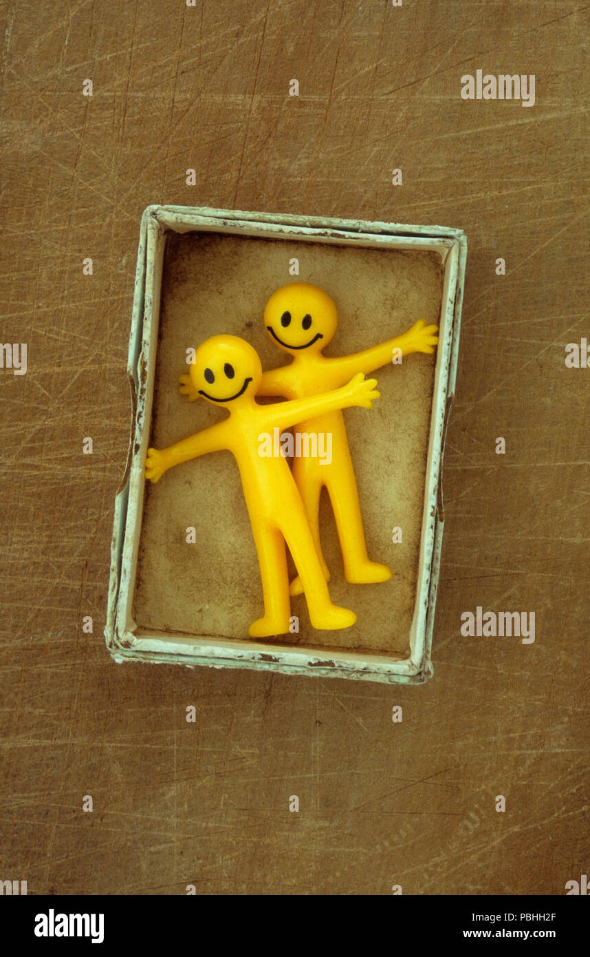 Two yellow plastic smiley bendy men with open arms and hugging Stock ...