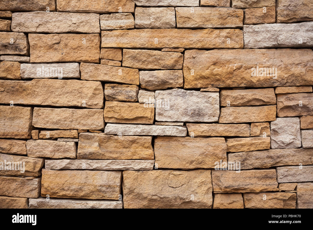 Stone wall background Wall made of cavern rock Stock Photo - Alamy