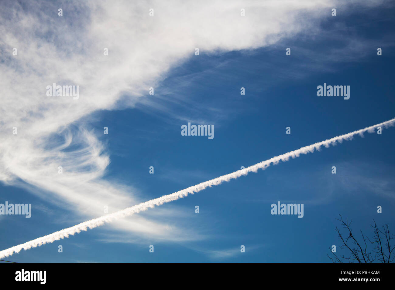 Clouds with jet trail Stock Photo - Alamy