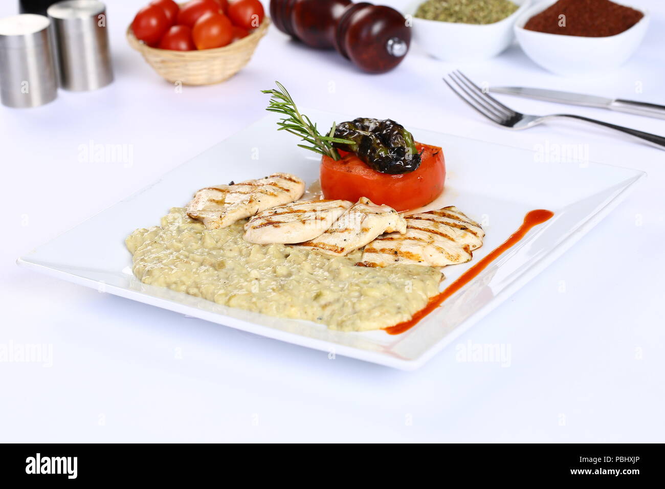 Grill fish fillet with tarator, humus Stock Photo - Alamy