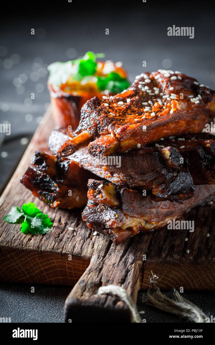 Spicy and tasty roasted ribs with potato and sesame Stock Photo - Alamy