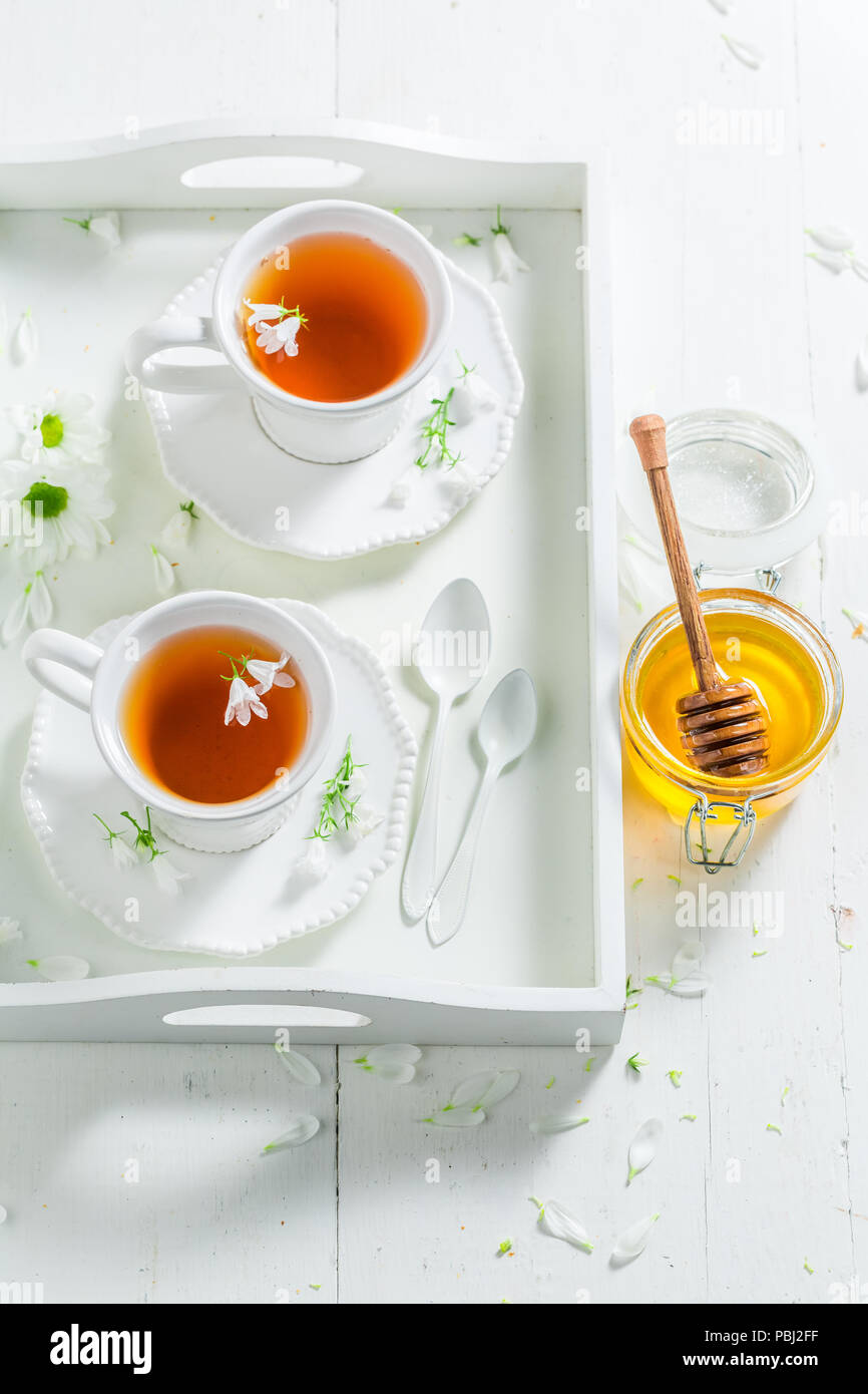 Sweet tea with honey on white background Stock Photo - Alamy