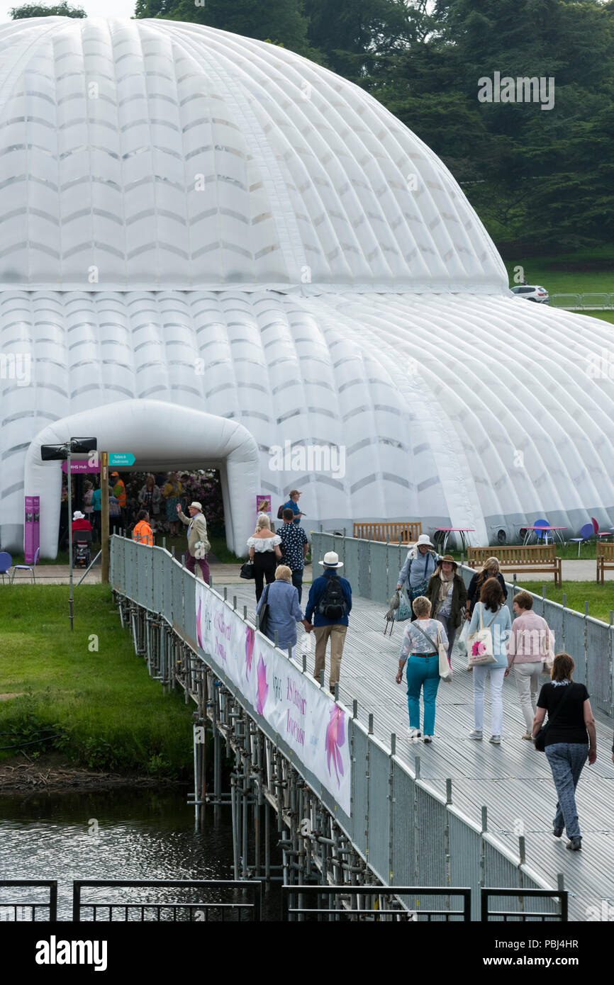 People at RHS Chatsworth Flower Show walking & crossing temporary river ...