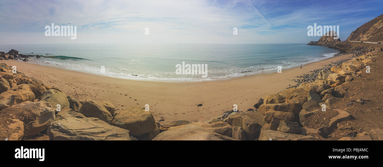 Panoramic coastal view of a sandy beach and the Point Mugu Rock along ...