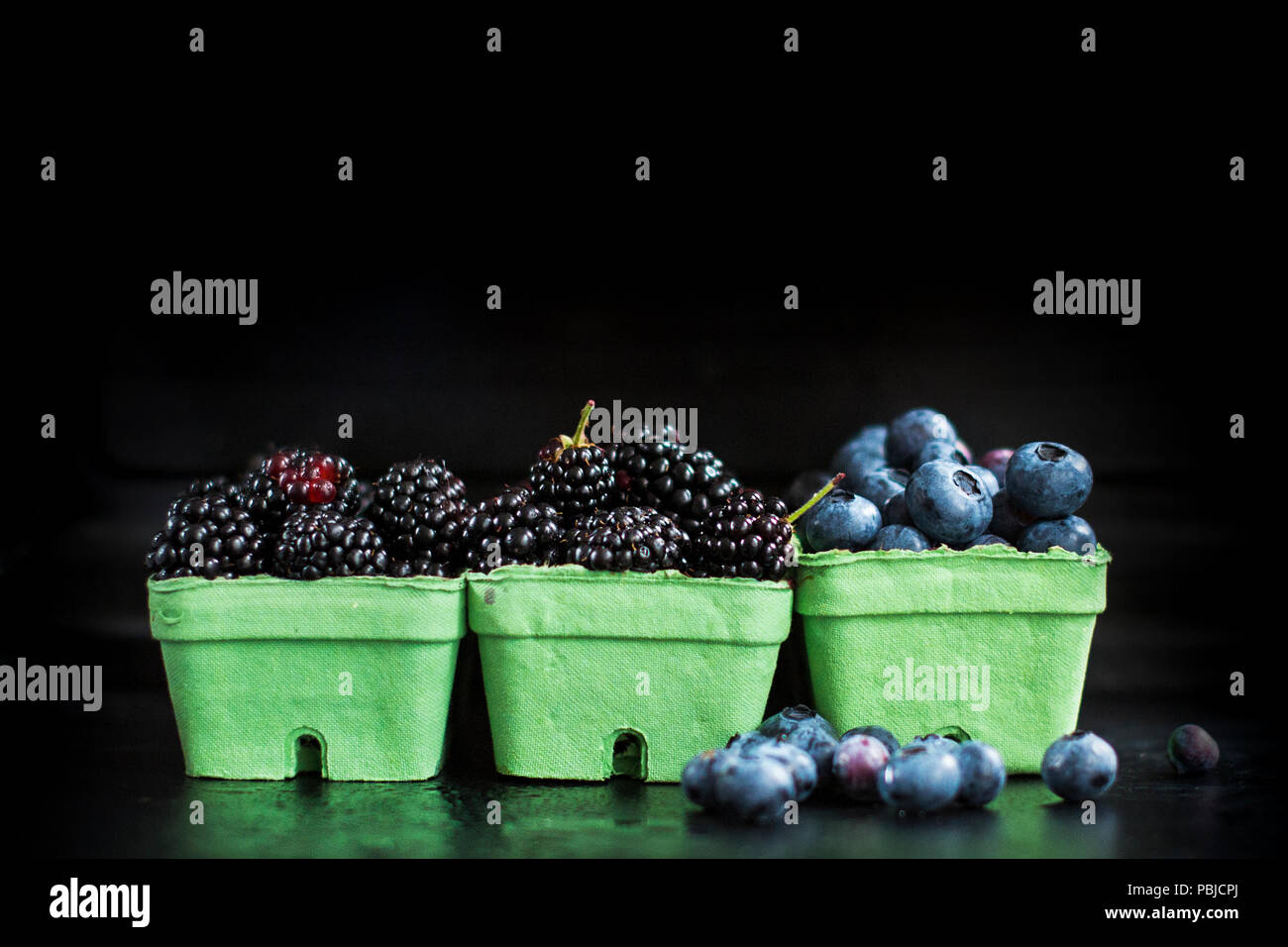 blueberry blackberries in pictures on a black background. Summer ...
