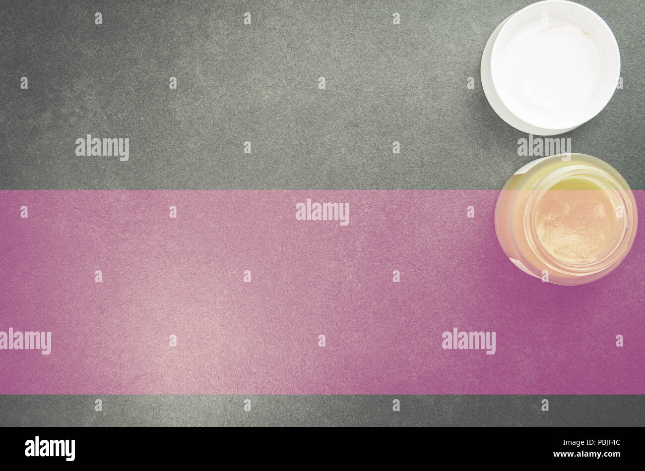 skin care cream container on a stone surface - directly above view ...