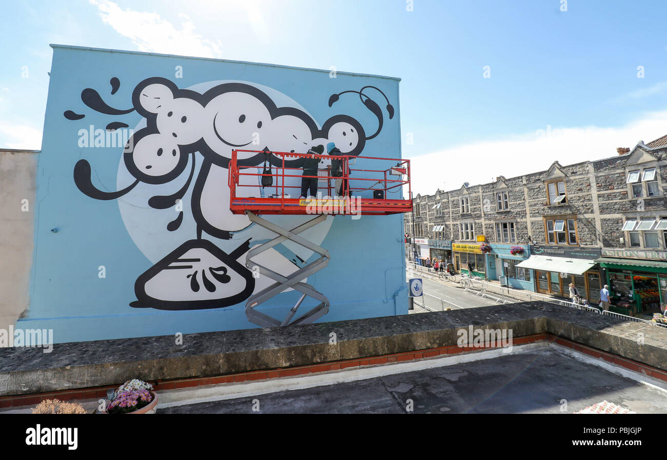 Artists paint on the side of a building during the Upfest 2018 festival ...