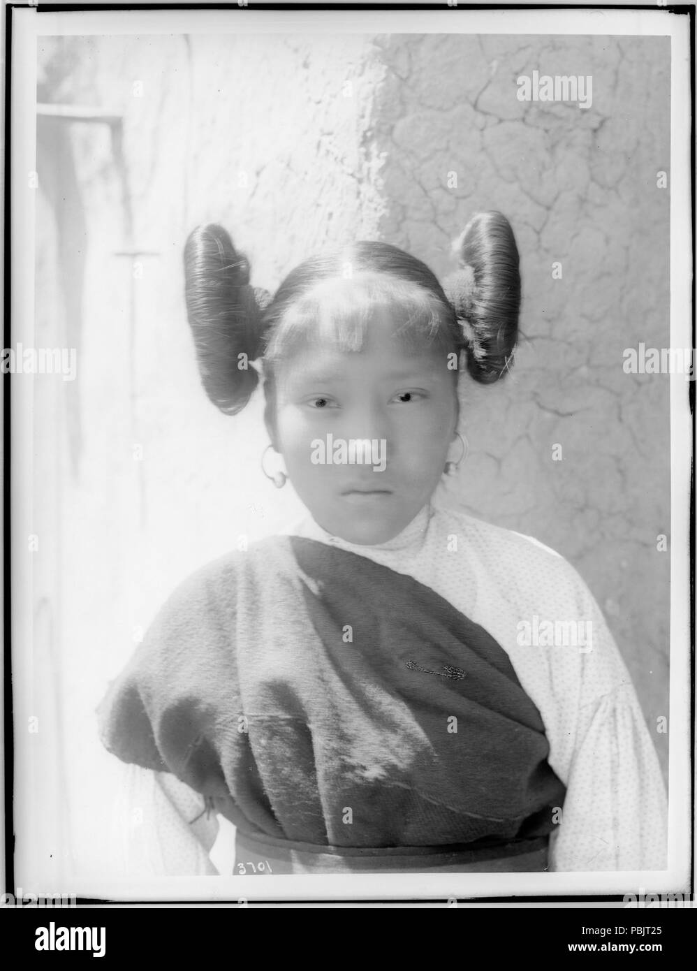 1878 Young Hopi Indian girl with hair worn up in large buns at the side ...