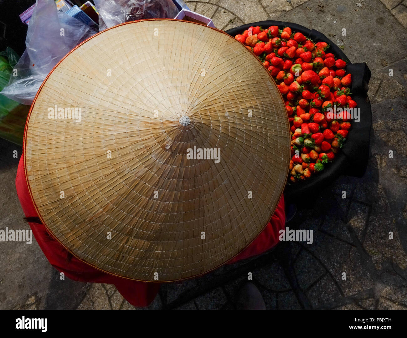 Strawberry fruits with a conical hat at rural market in spring Stock ...