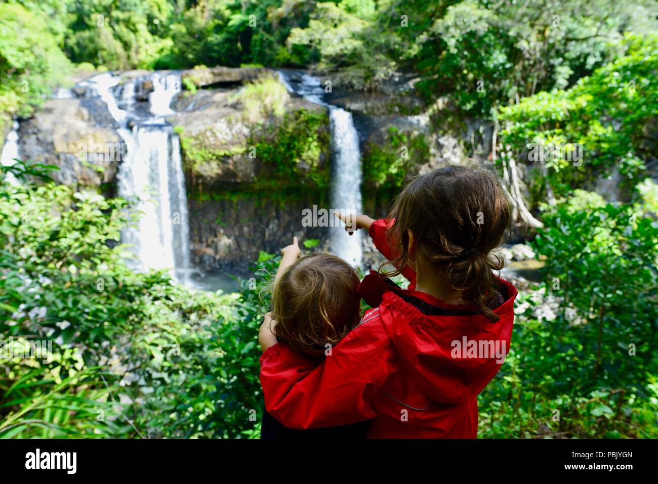 Two children pointing at a waterfall hi-res stock photography and ...