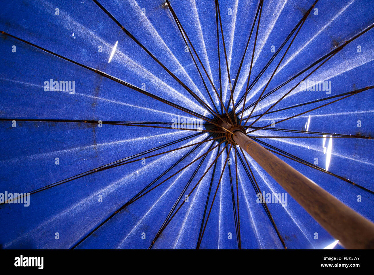 Under of blue color umbrella Stock Photo - Alamy