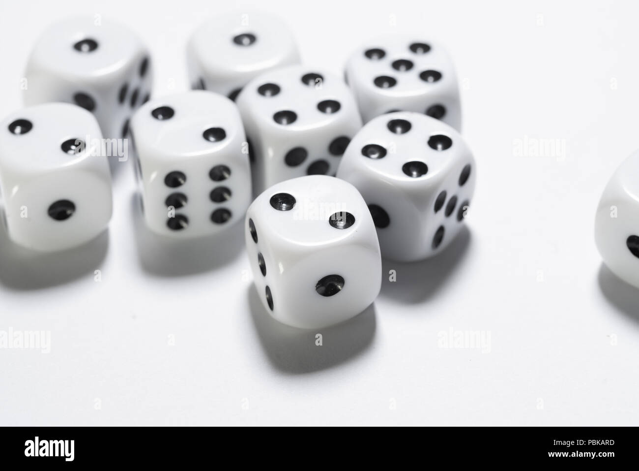 Macro shot of multiple dice on white background Stock Photo - Alamy
