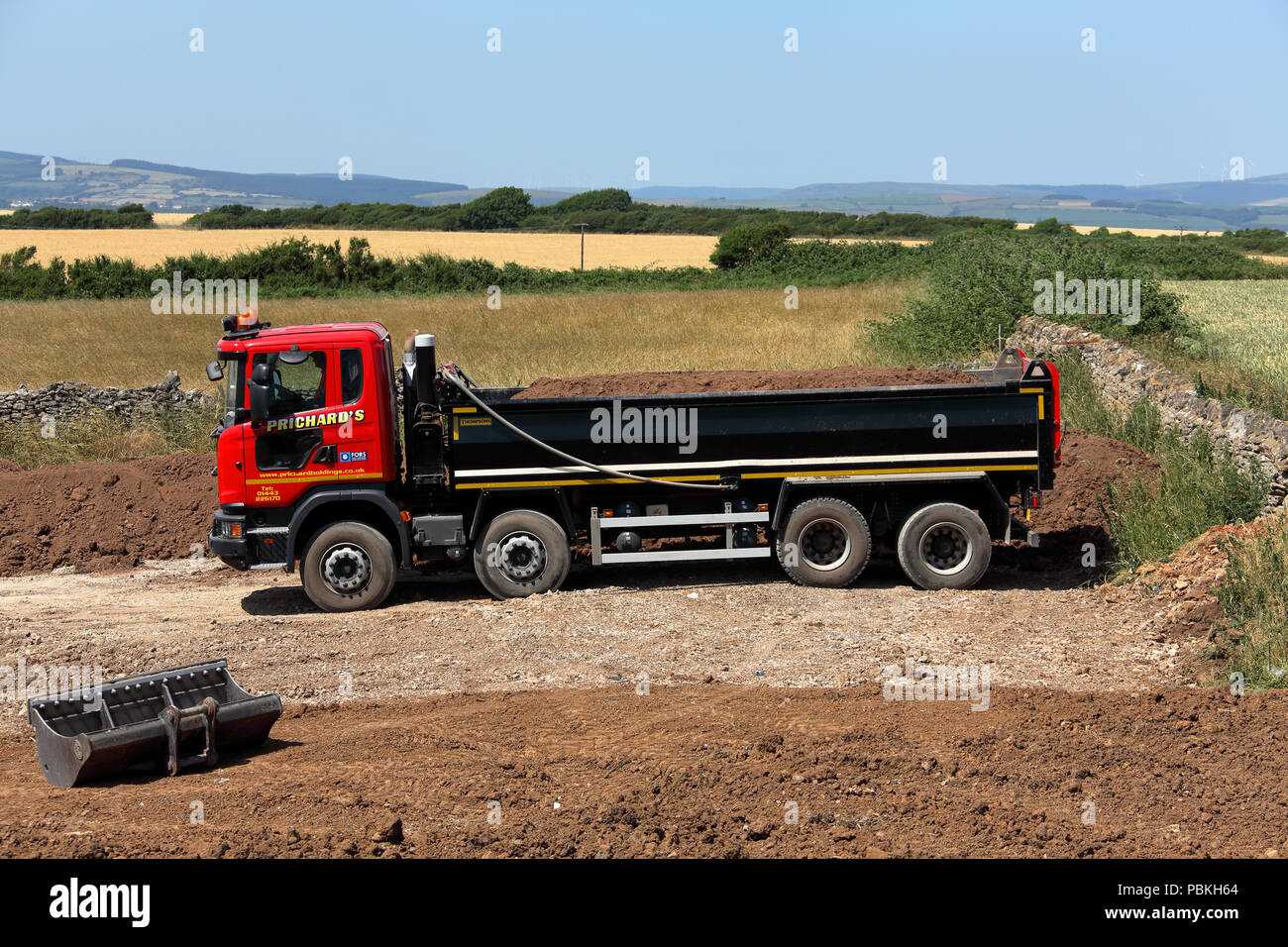 Anew tipper lorry delivering its full load of fresh earth during ...