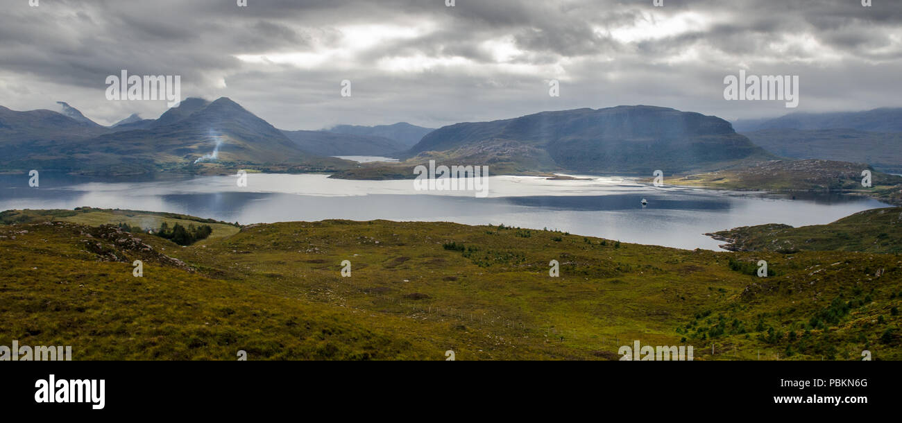 A fishing boat passes through Loch Torridon, an inlet of the Atlantic ...