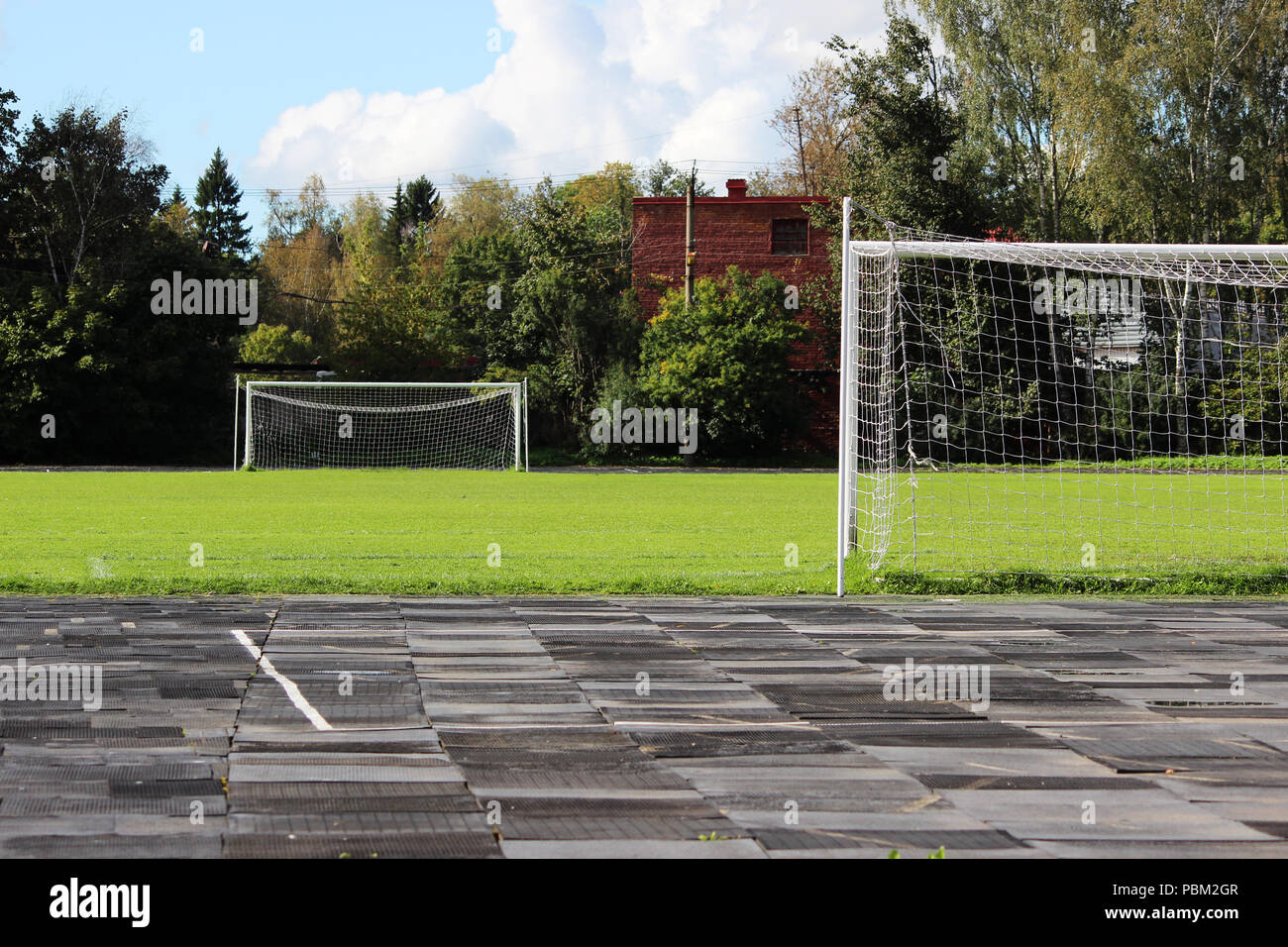 stadium: a treadmill with rubber plates and a football field with a ...