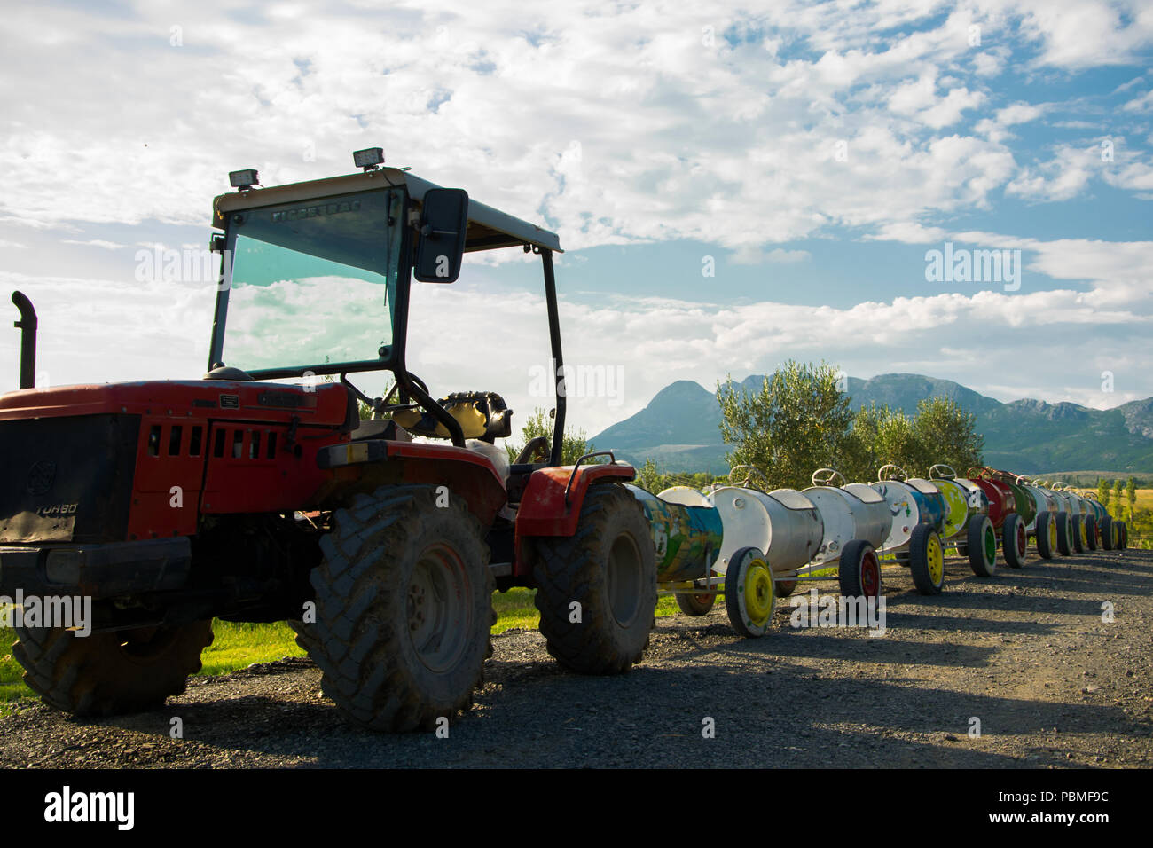 Agricultural tractor equipped with small wagons to make trips to ...