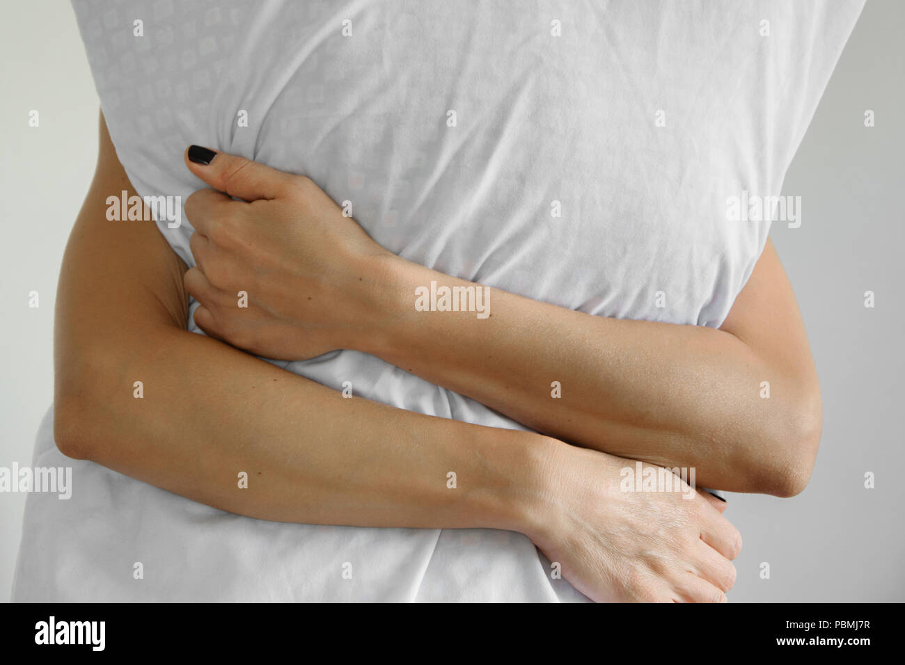 Close up of womans hands hugs a pillow Stock Photo - Alamy