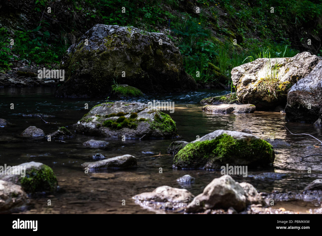 water flowing between the rocks Stock Photo - Alamy