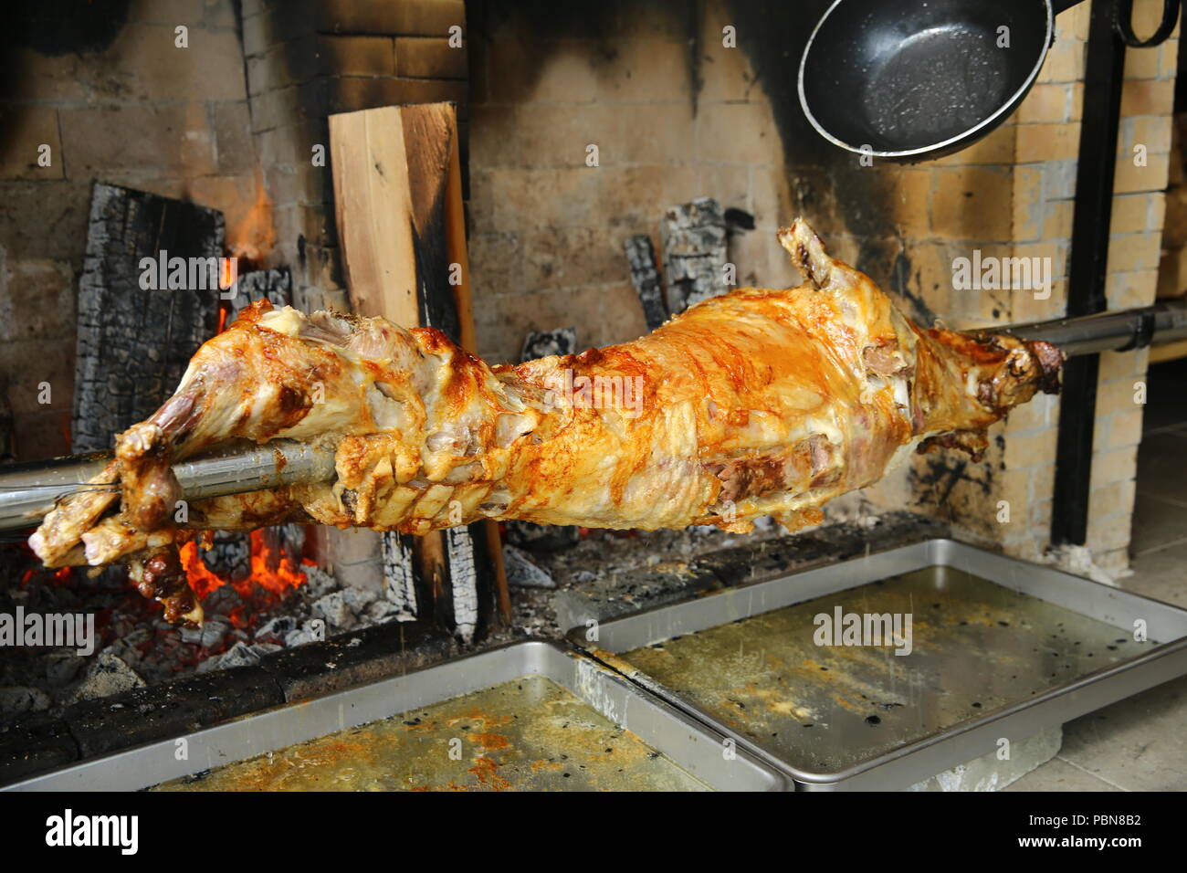 Roast lamb on a spit on fire Stock Photo - Alamy